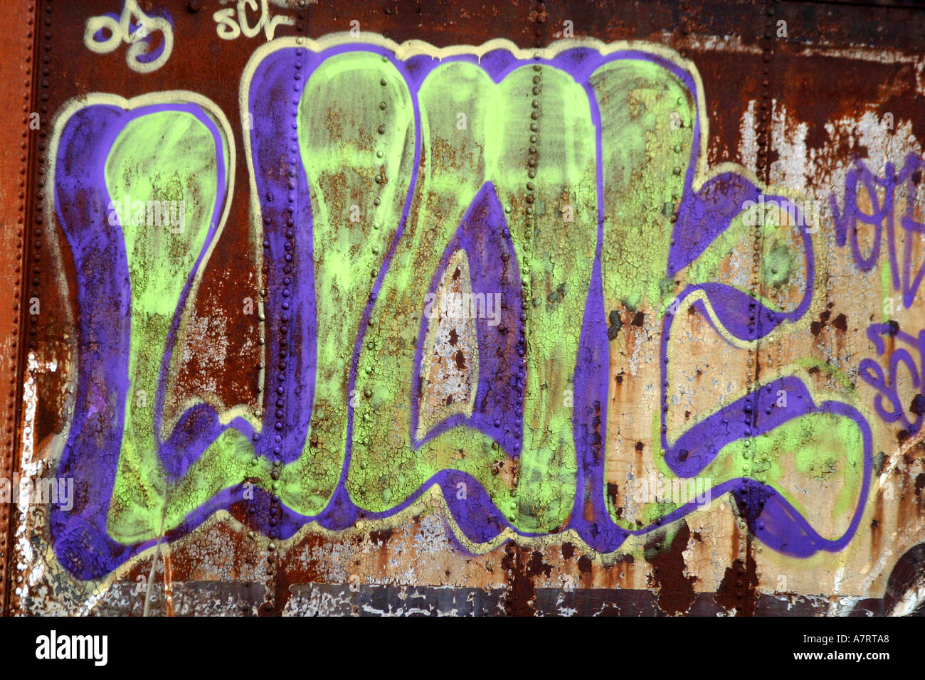 Graffiti on the side of a rusty old fuel tank Stock Photo - Alamy