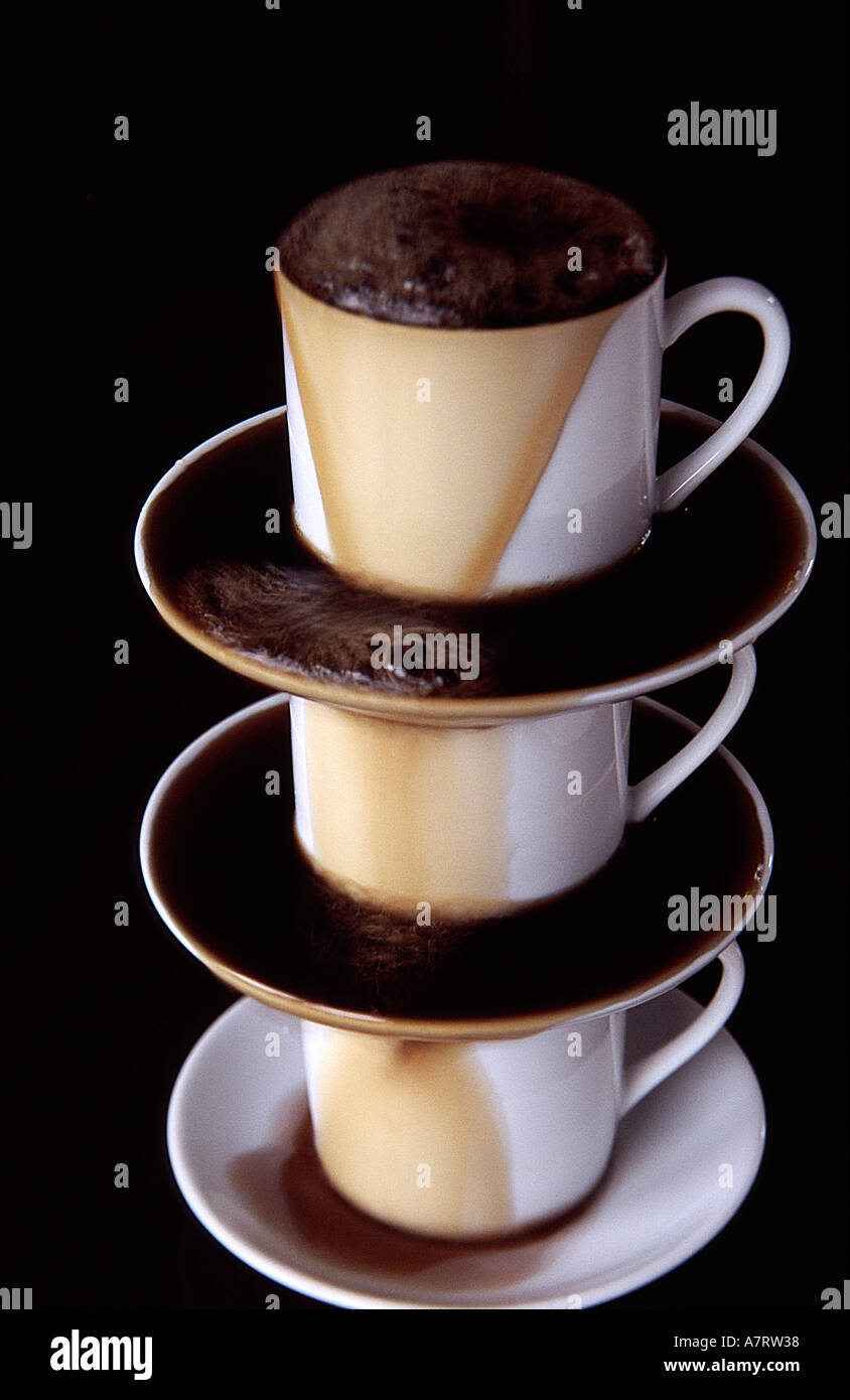 Stacked coffee cups with coffee flowing like a fountain Stock Photo - Alamy