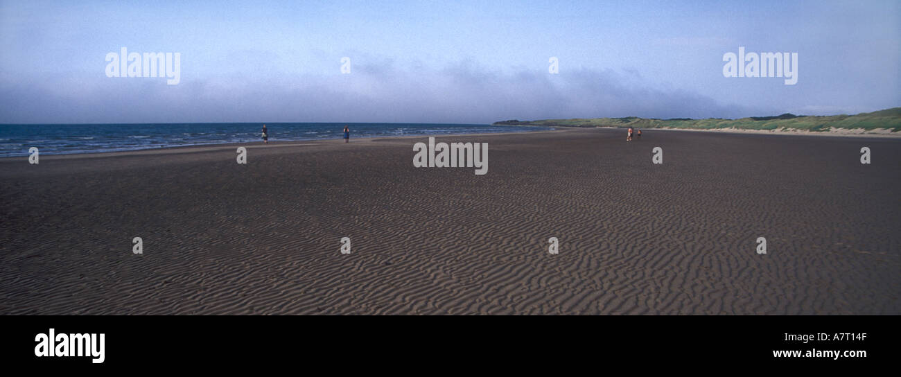 Panoramic beach scene with sand sea sky beaches dunes and people ...