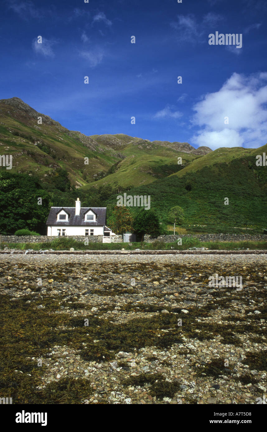 Traditional white washed crofters cottage on the shores of Loch Hourn ...