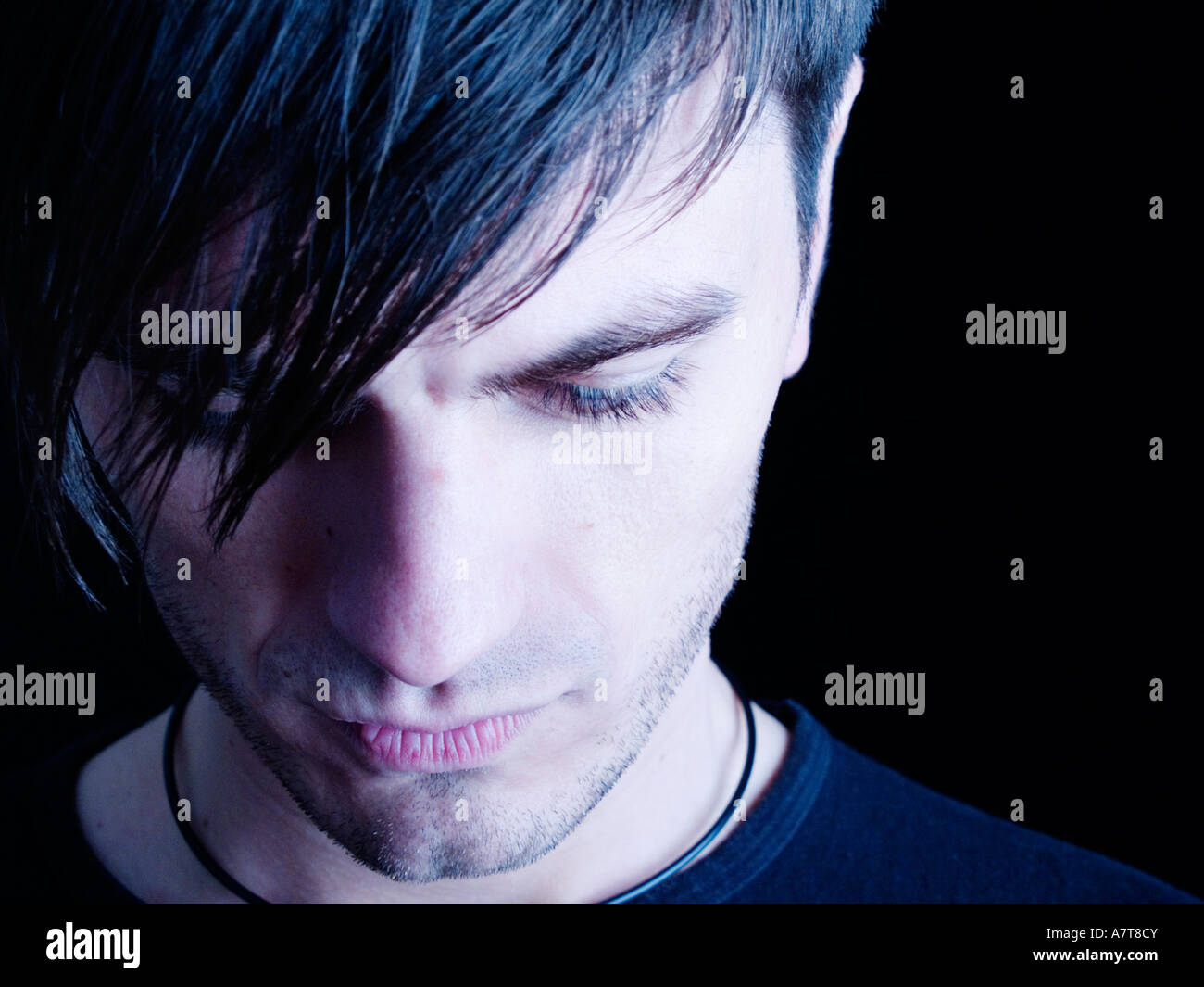 Young man looking down Stock Photo - Alamy