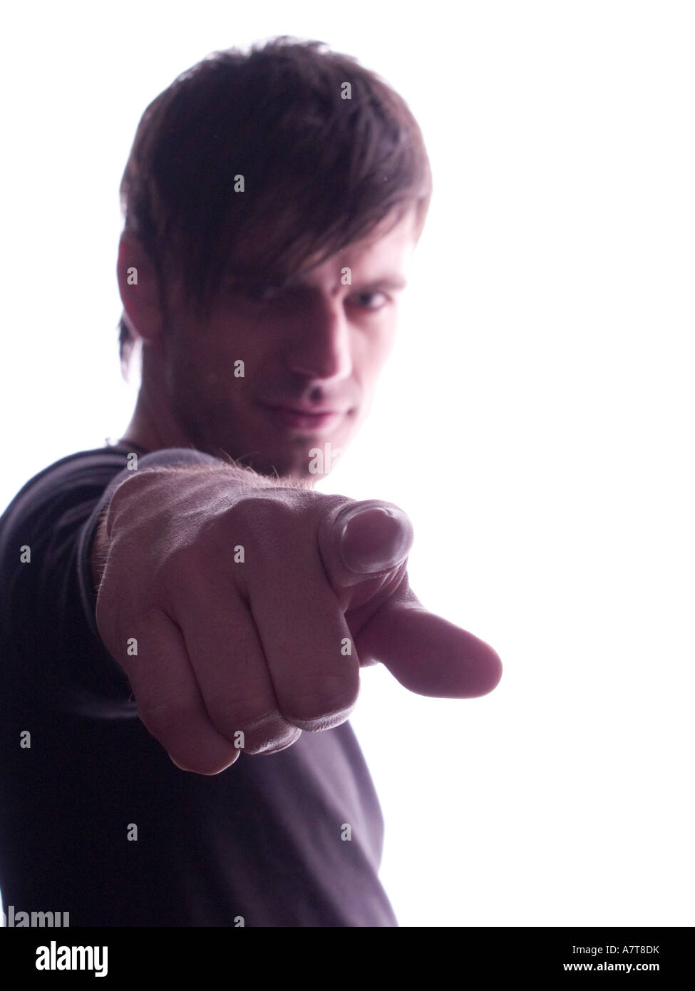 Portrait of young man pointing Stock Photo - Alamy