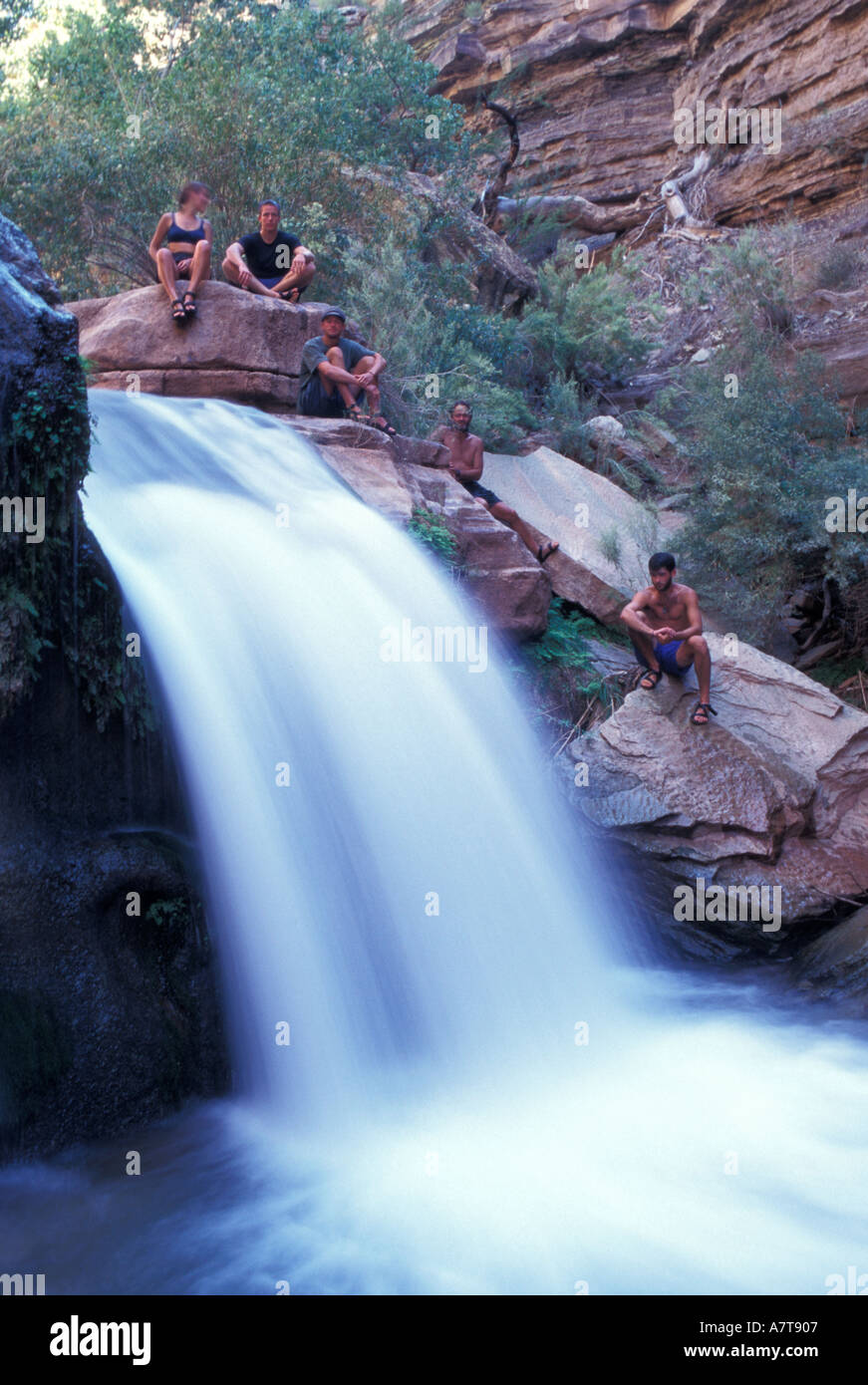 People Resting Near a Waterfall Stock Photo - Alamy