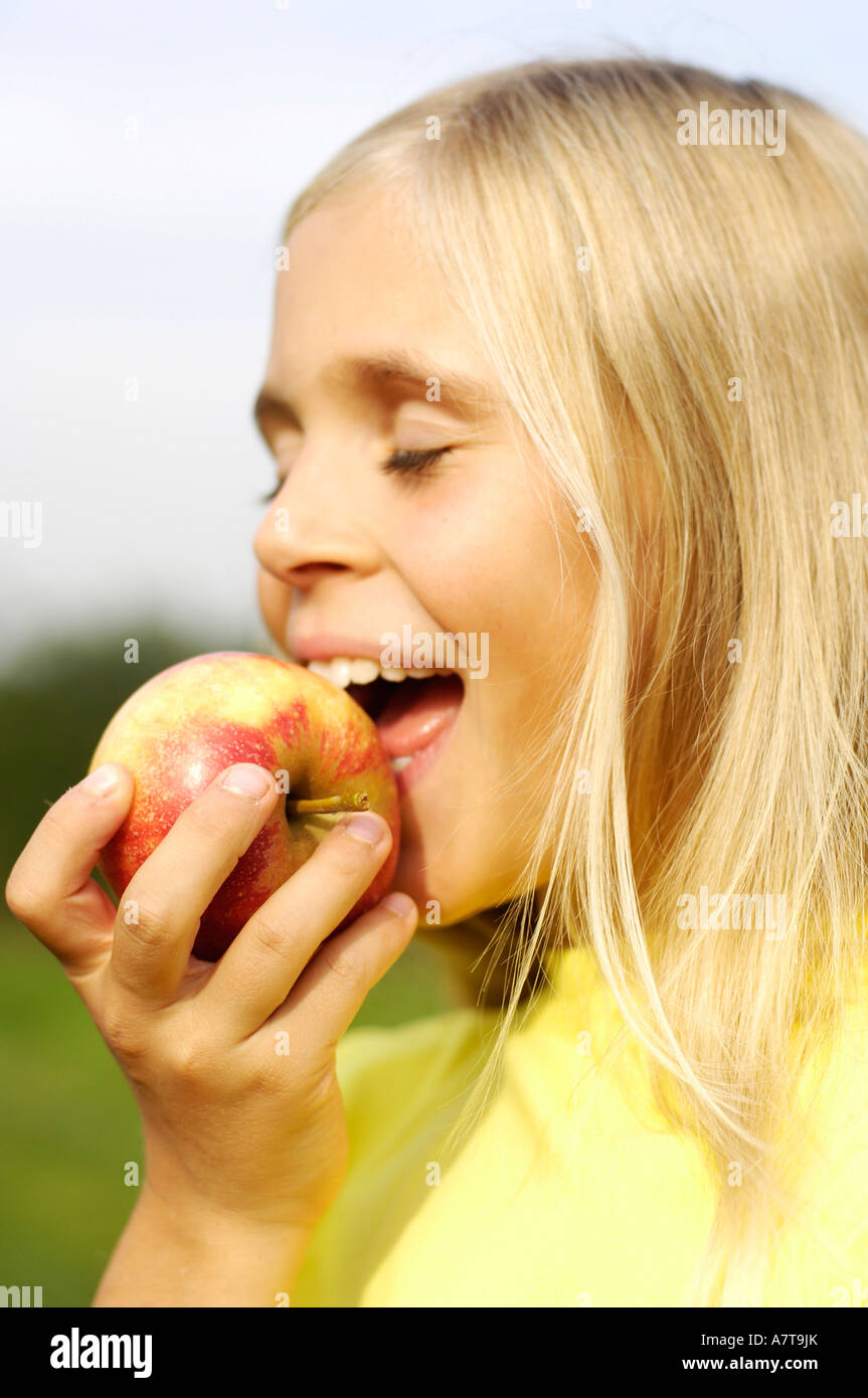 Girl eating apple Stock Photo - Alamy