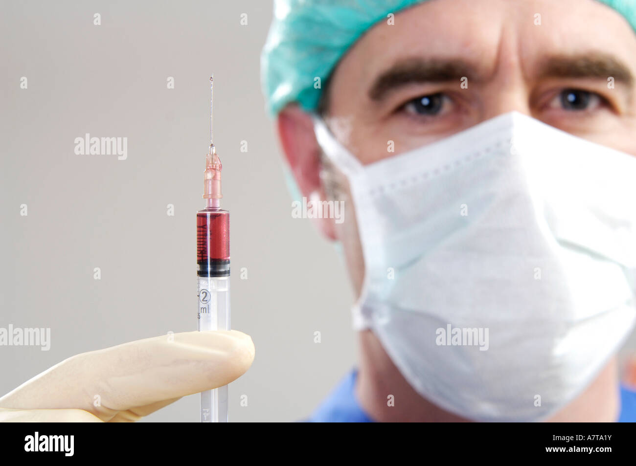 Portrait of male surgeon holding syringe Stock Photo - Alamy