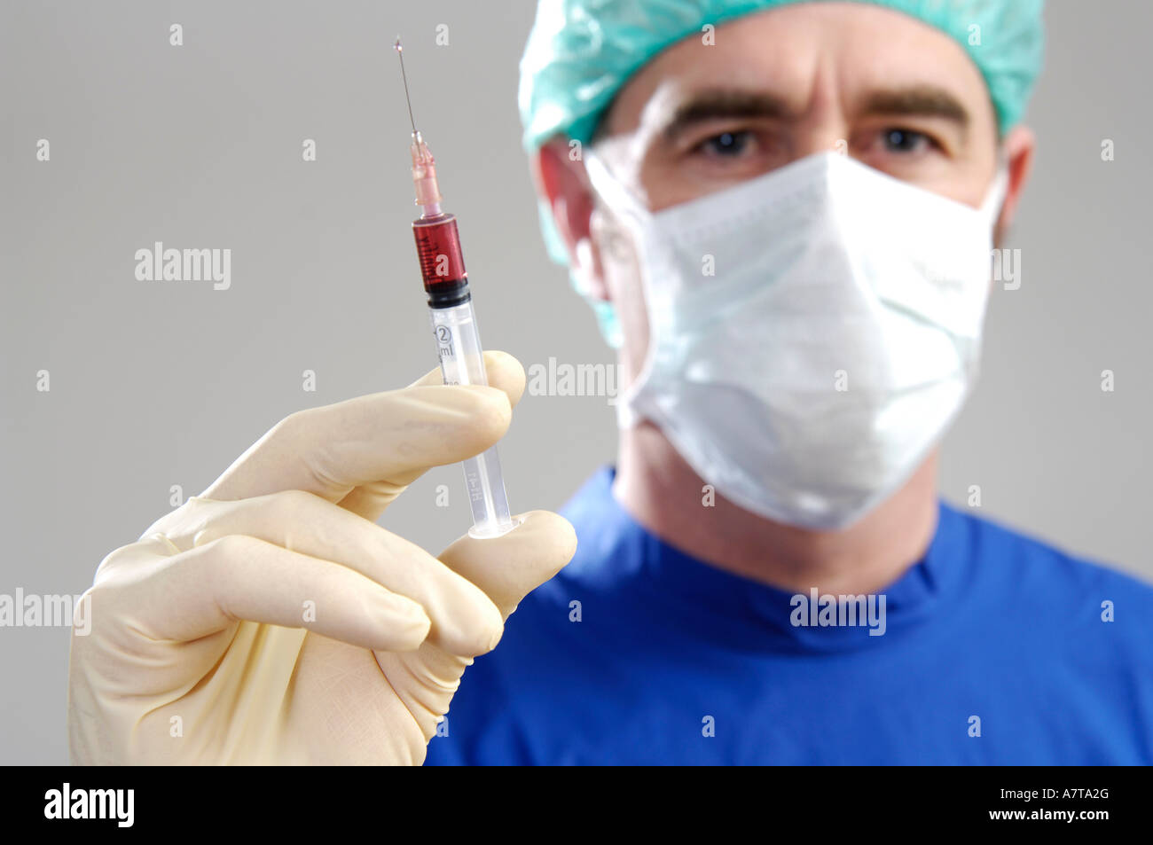 Portrait of male surgeon holding syringe Stock Photo - Alamy