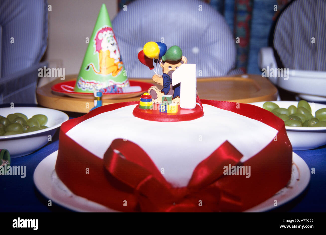 Table laid for a baby s first birthday tea with birthday cake and ...