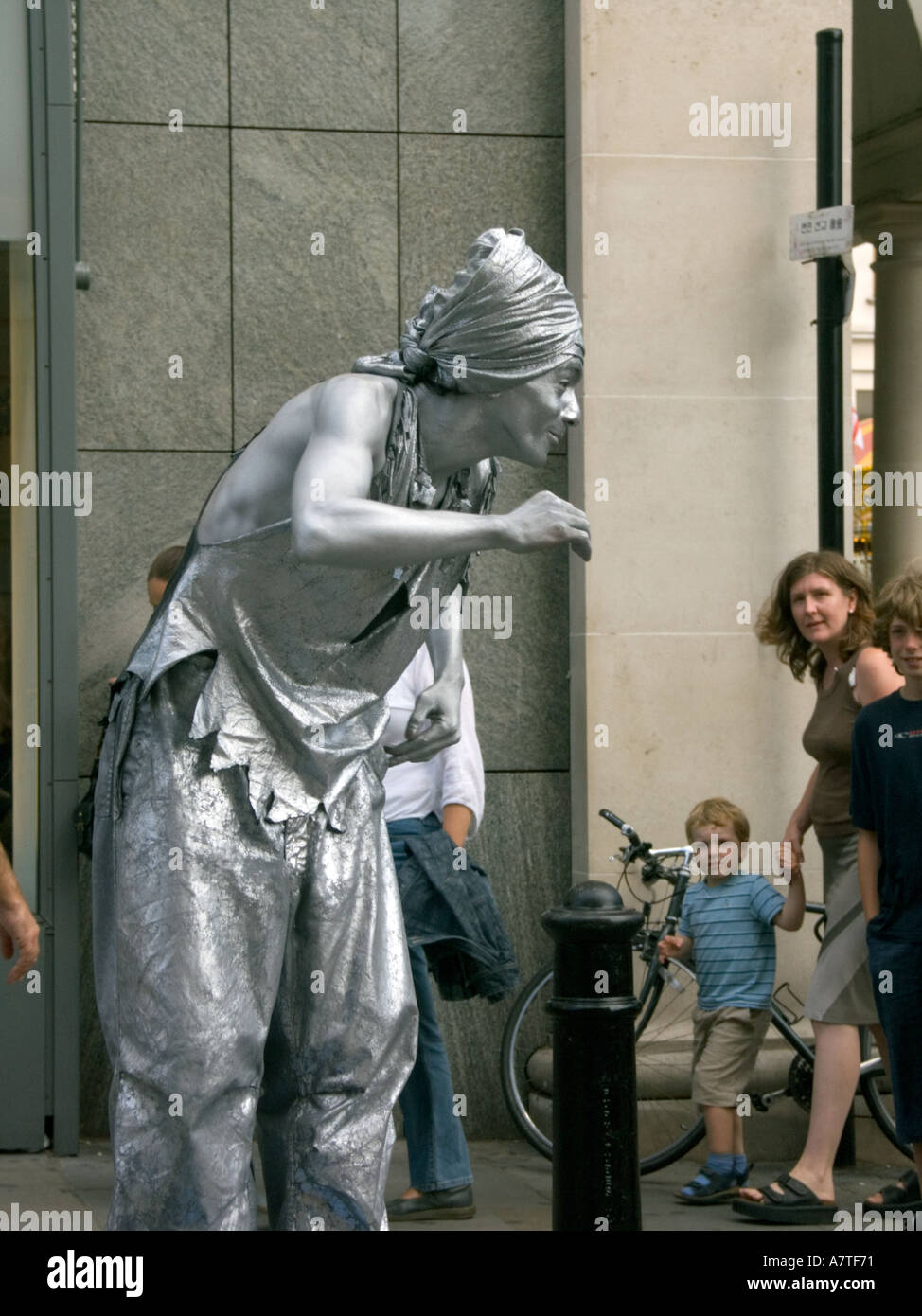 Silver painted street performer entertainer hi-res stock photography ...