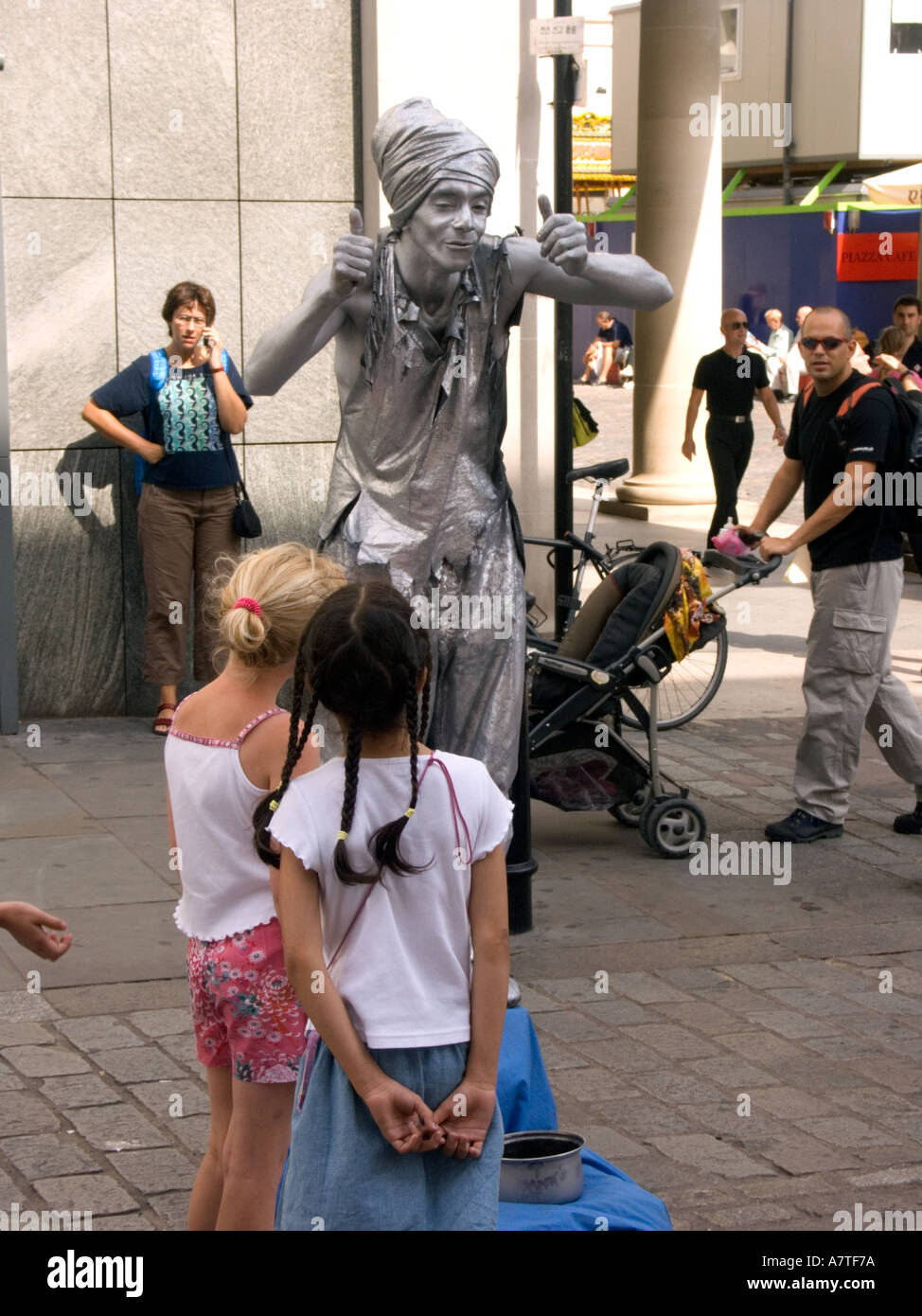 Silver Painted Street performer entertainer with children Covent Garden ...