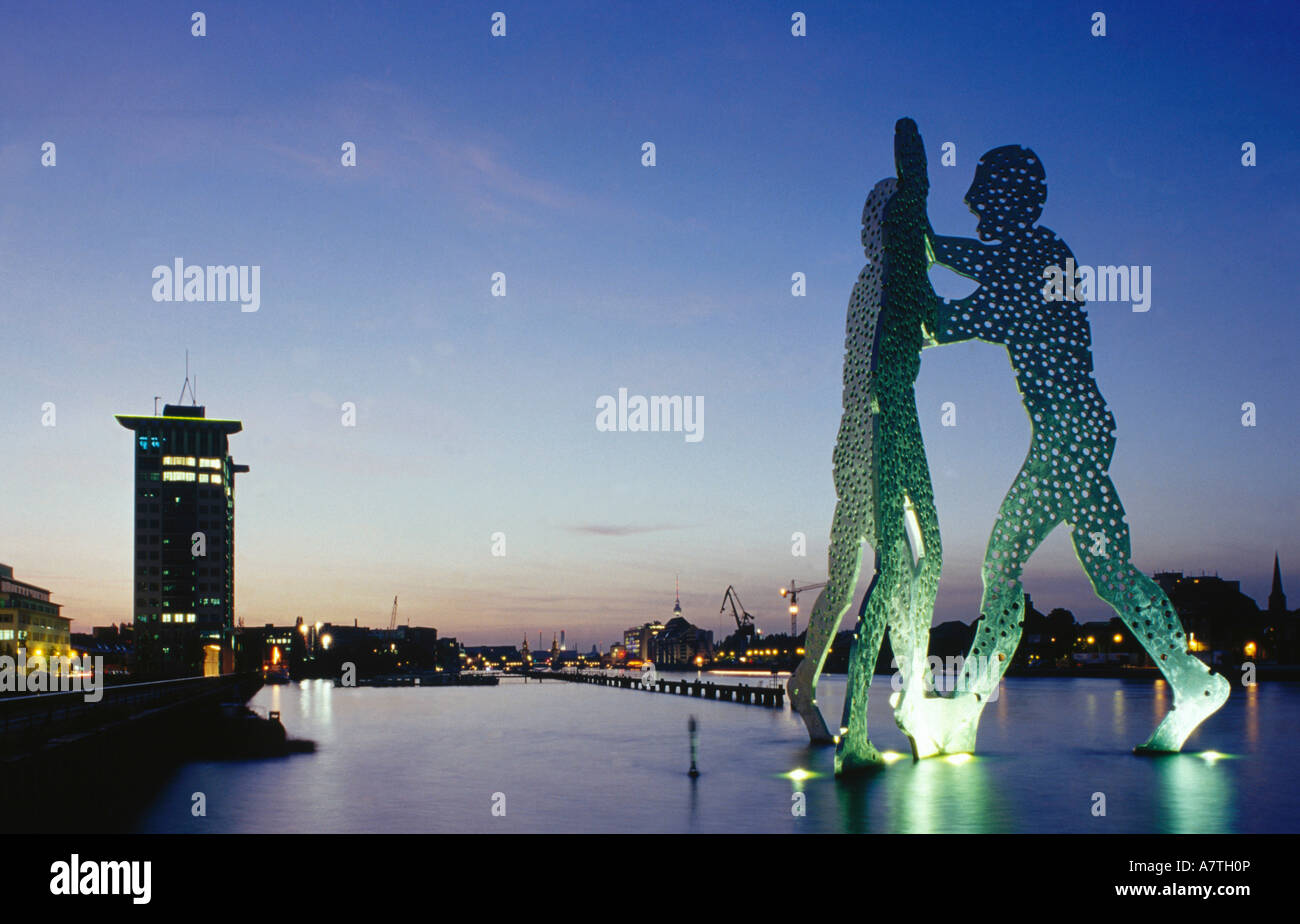 Monument lit up at dusk, Molecule Men, Berlin, Germany Stock Photo - Alamy
