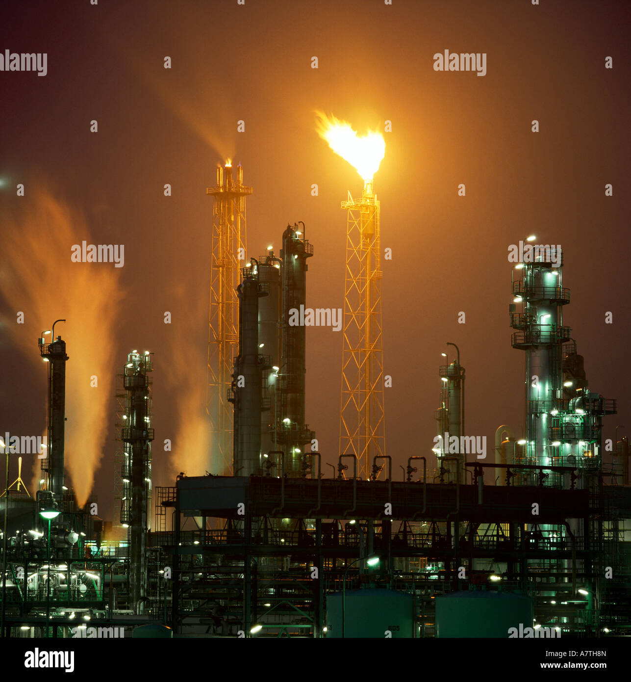 Oil refinery lit up at night Stock Photo - Alamy