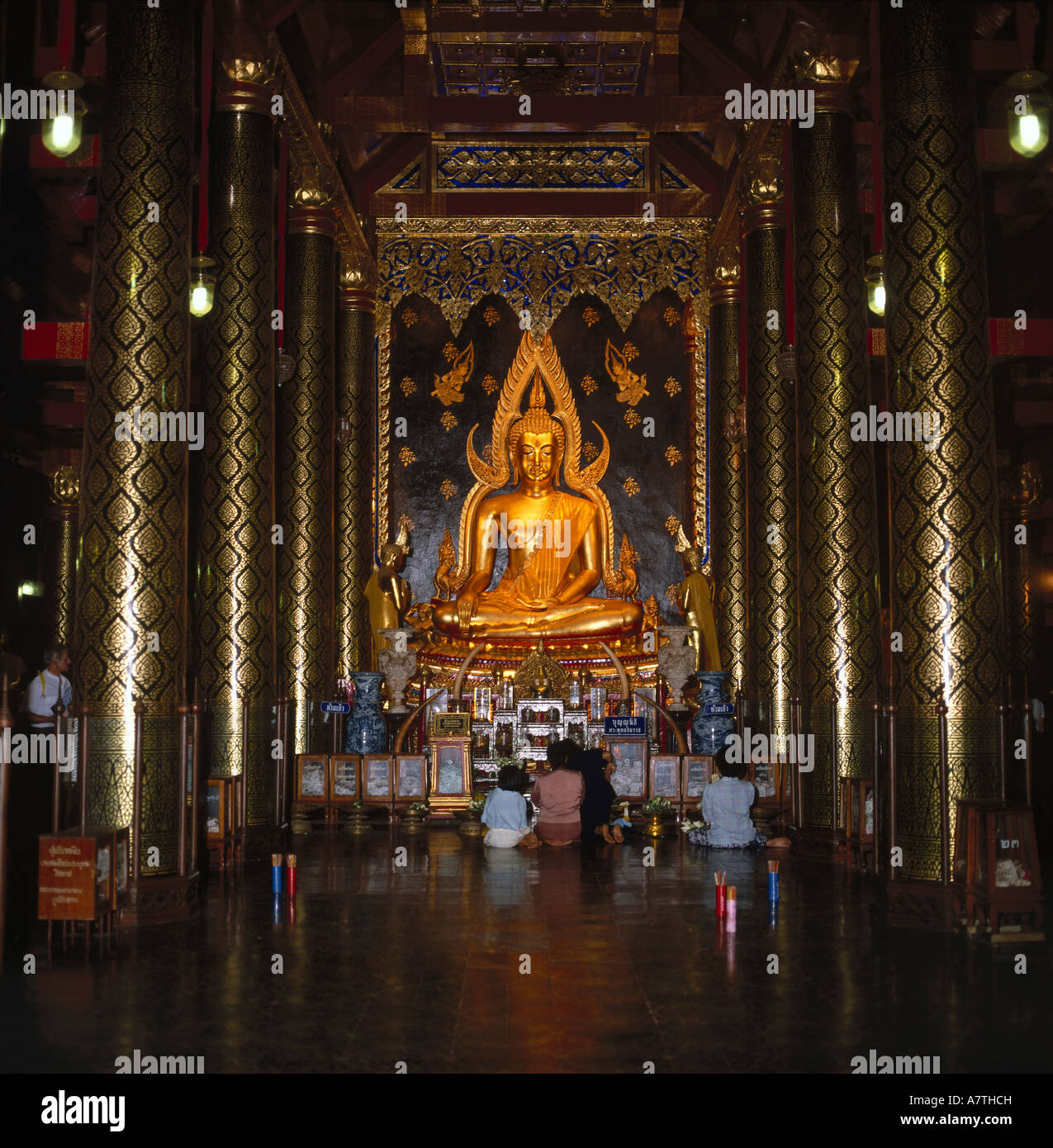 Worshippers praying inside temple, Phitsanulok, Thailand Stock Photo ...
