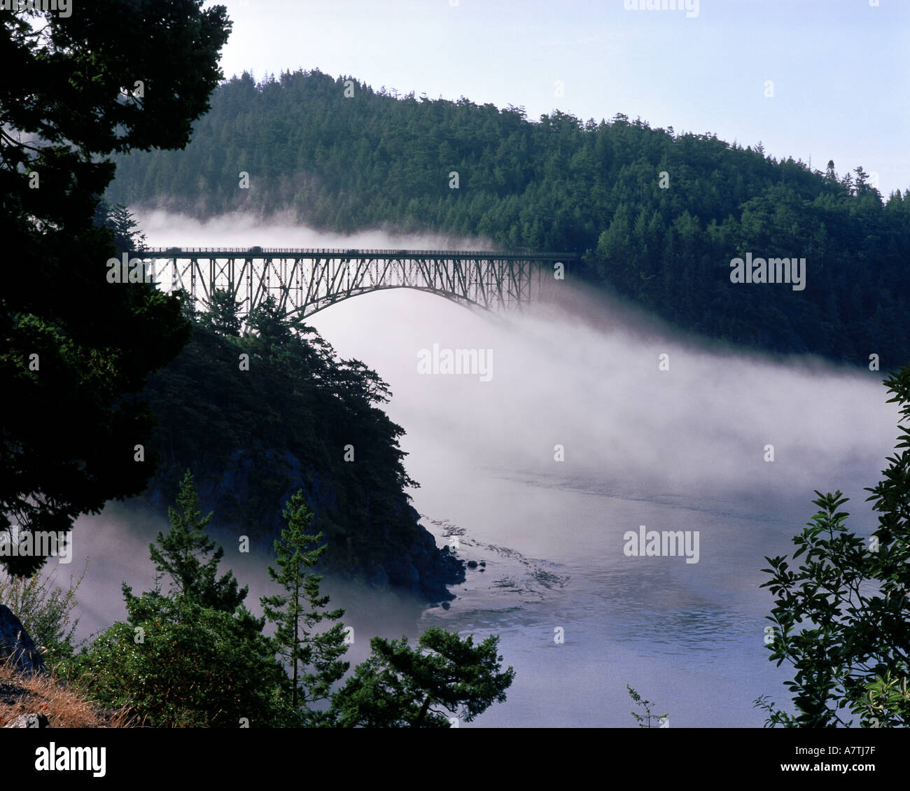 Fog drifts under the Deception Pass bridge at Deception Pass State Park ...