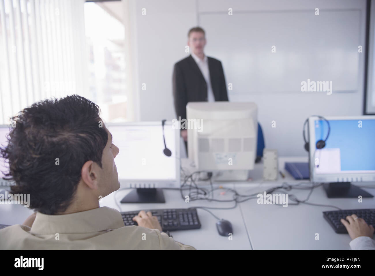 Rear view of businessman working on computer Stock Photo - Alamy
