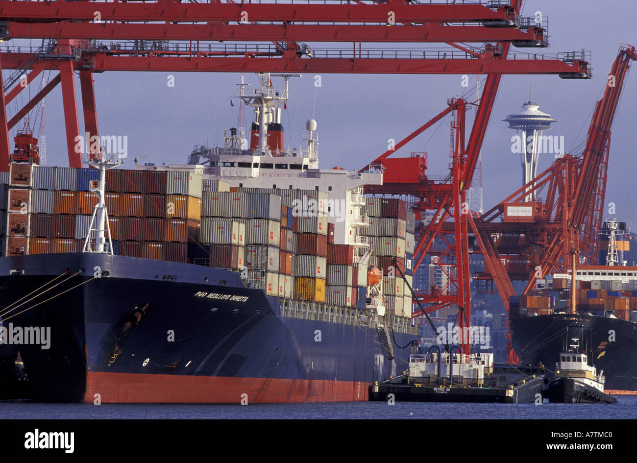 NA, USA, Washington, Seattle. Container ships taking on and unloading ...