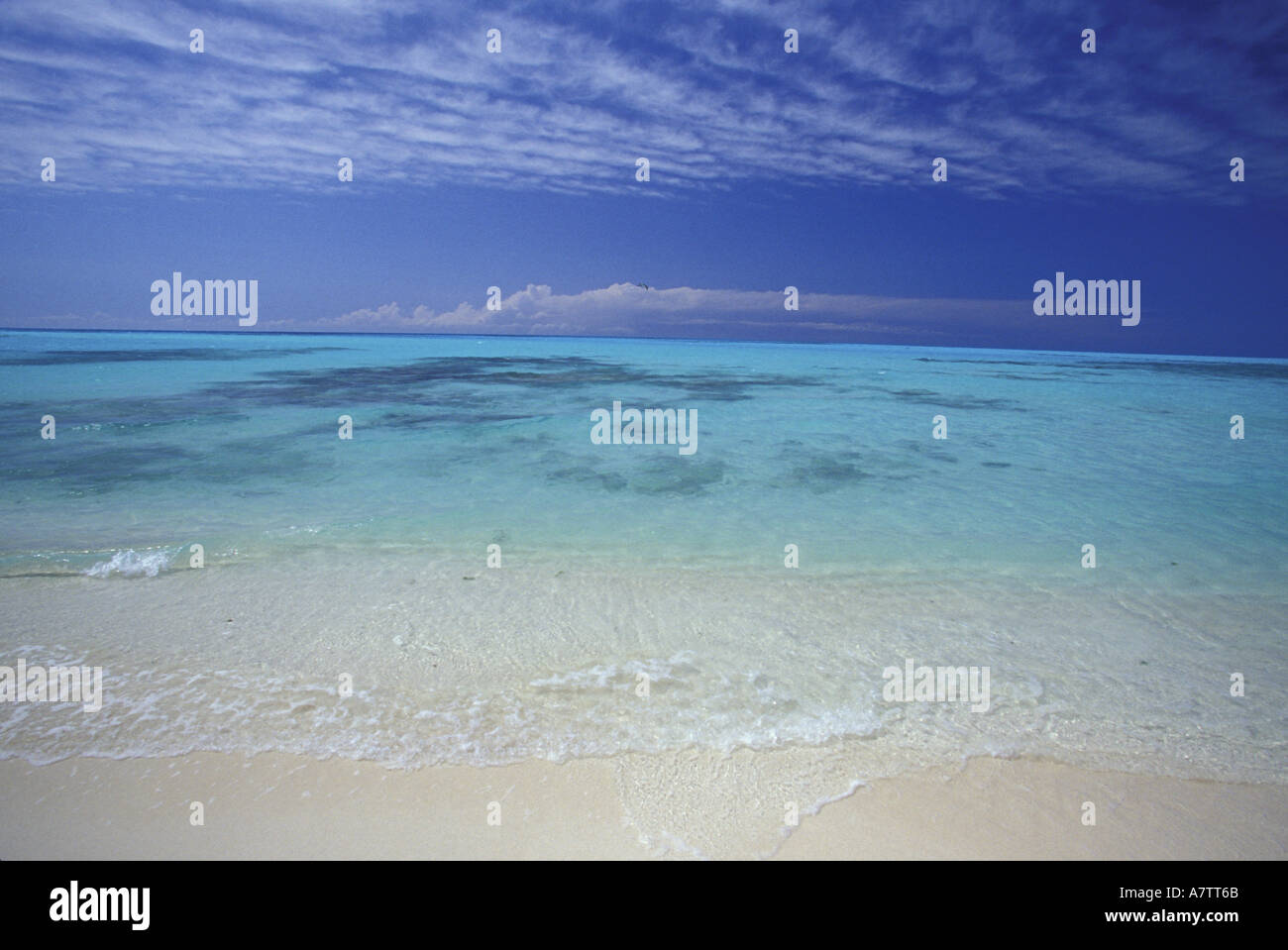 United States, Hawaii, Midway Atoll NWR. Blue water and white sand ...