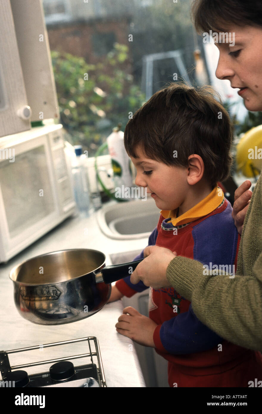 young mother cooking with young child Stock Photo - Alamy