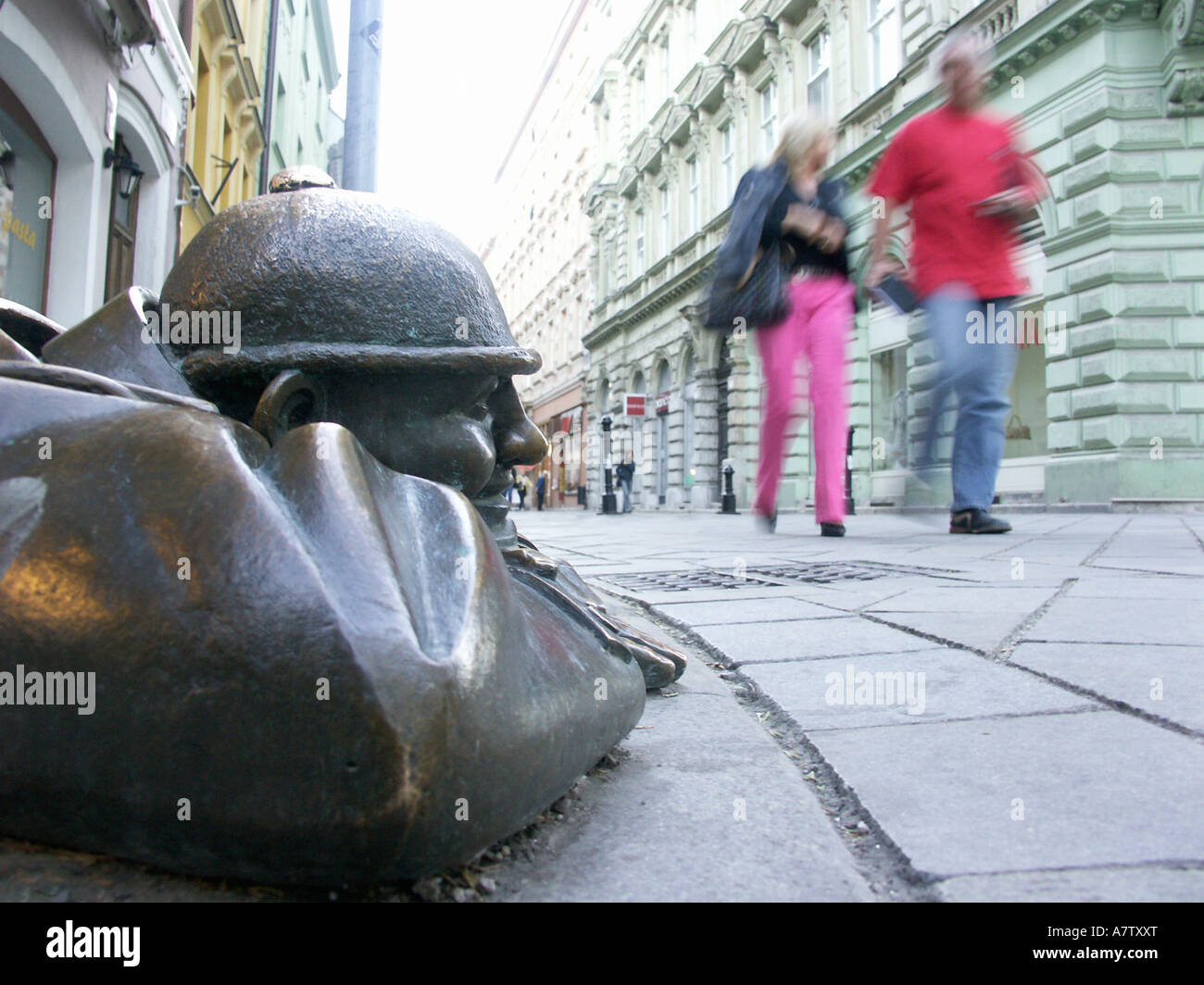 Cumil statue - a man sticking his head out of a gutter, with a blured ...