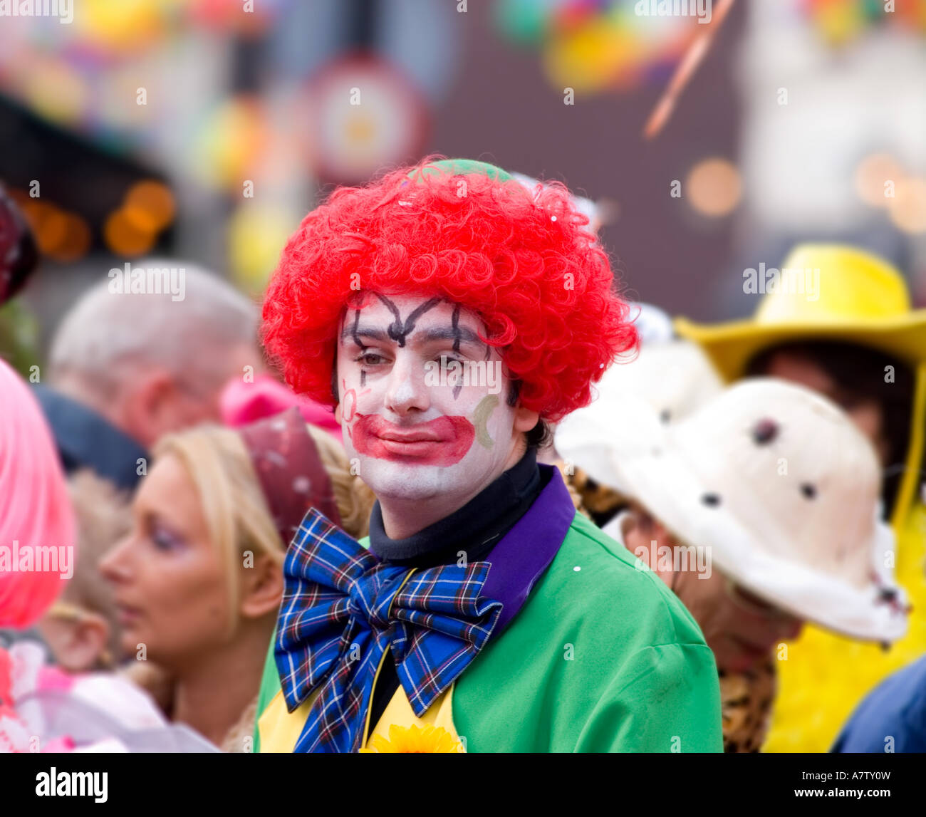 a clown in a crowd on a carnival parade Stock Photo - Alamy