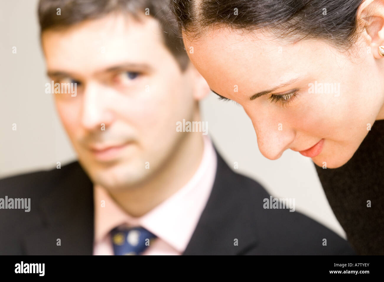 businesswoman looking down, her colleague looking on her flirting Stock ...