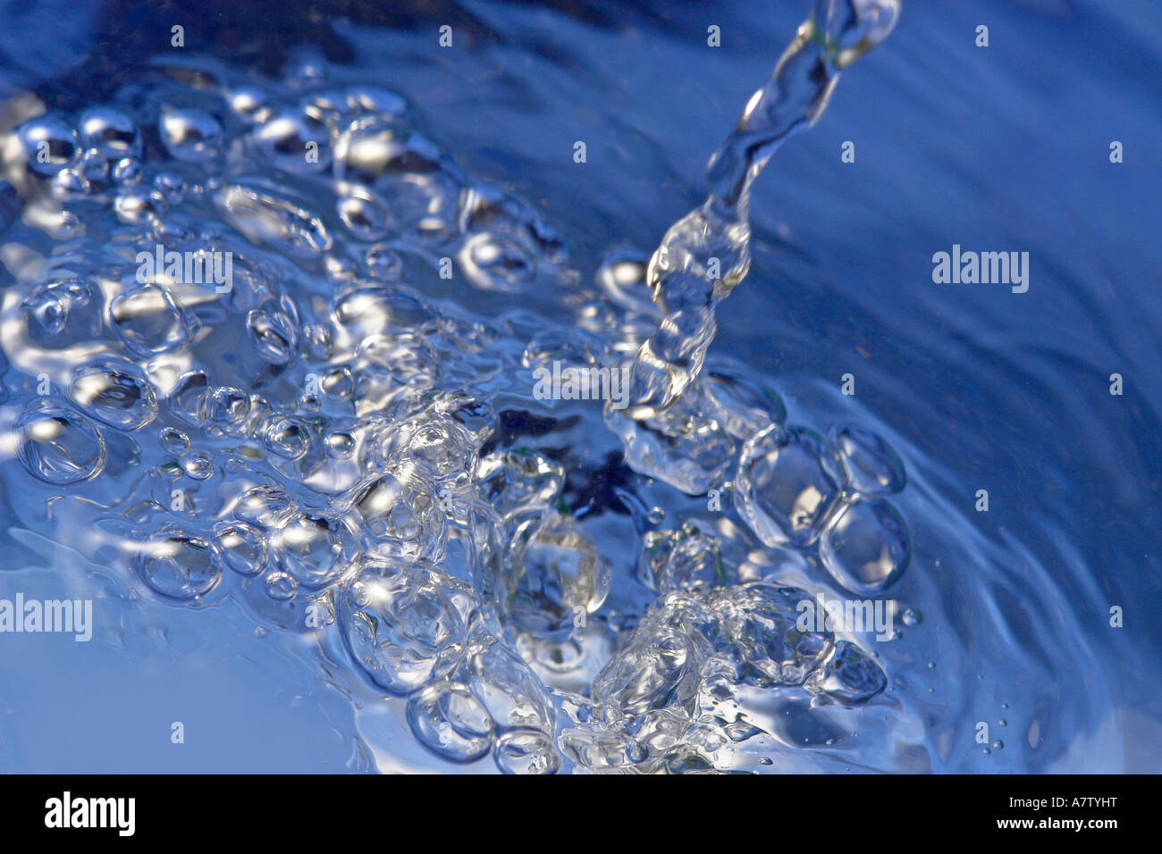 Water droplets creating ripples on water surface Stock Photo - Alamy