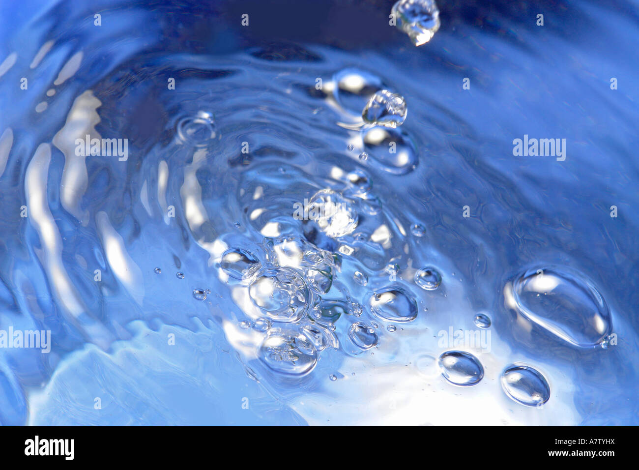 Water droplets creating ripples on water surface Stock Photo - Alamy