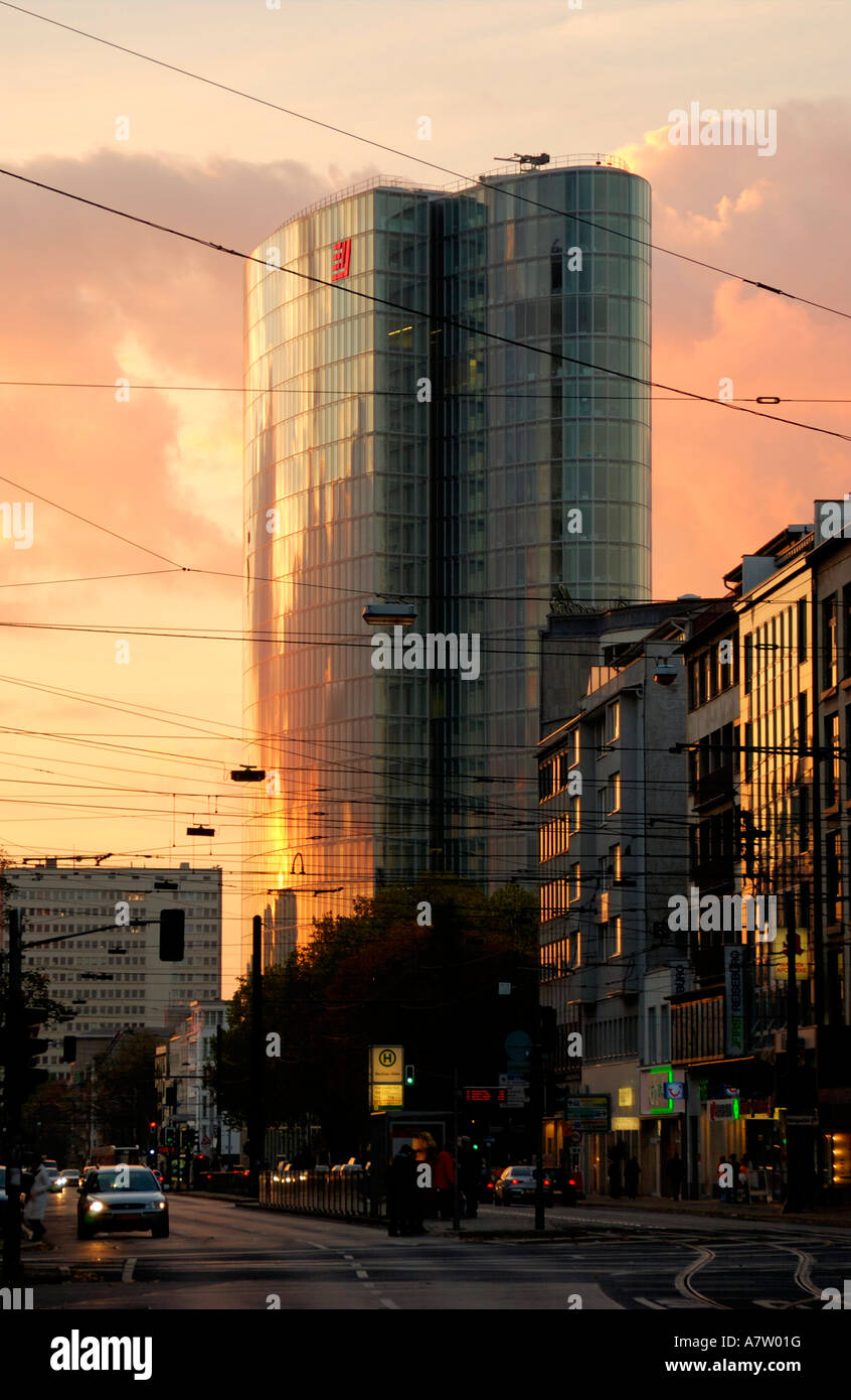 Transmission lines in front of buildings in city at dusk Stock Photo ...