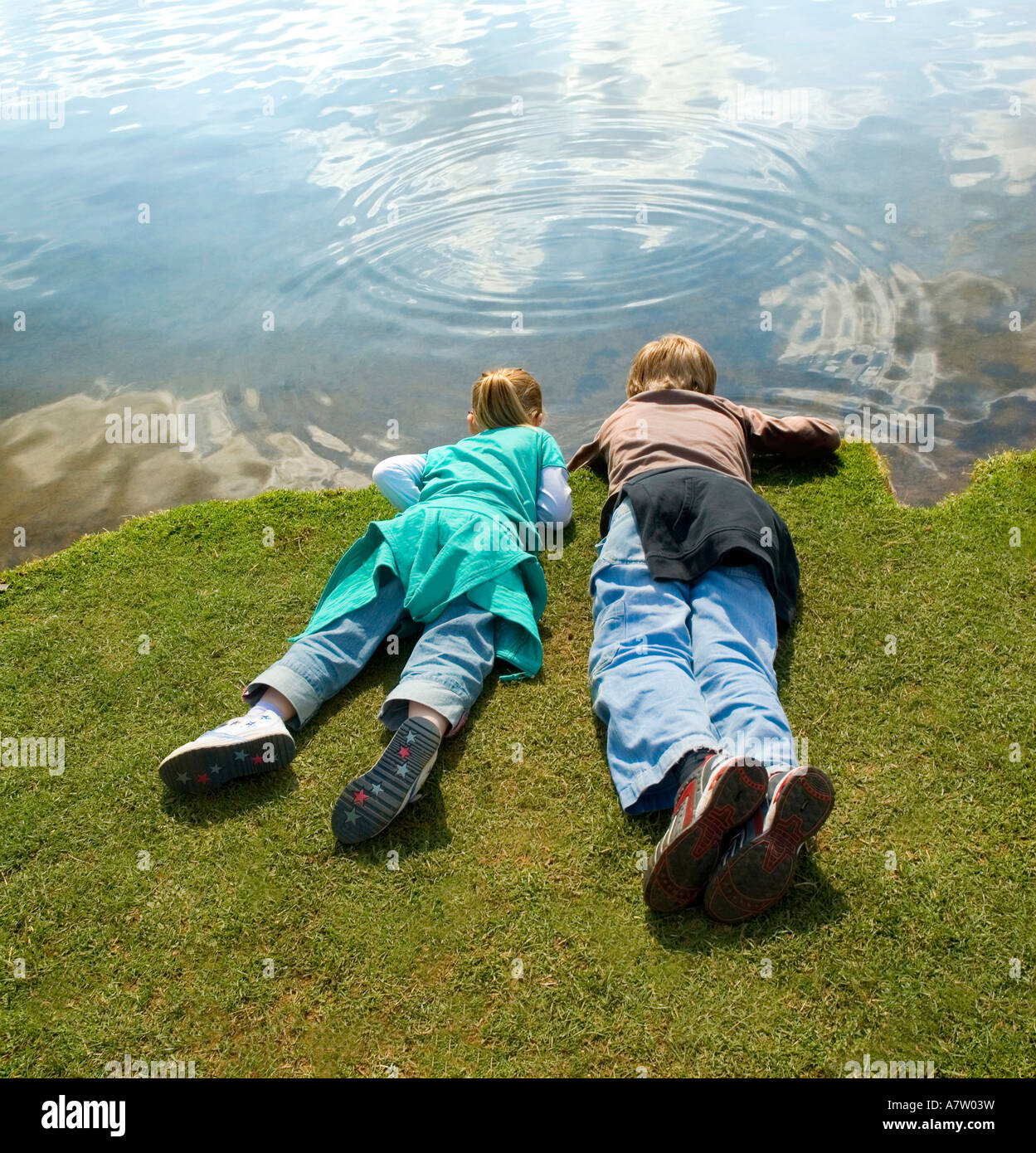 A Brother and Sister looking into Water from Staith RutlandWater Stock ...