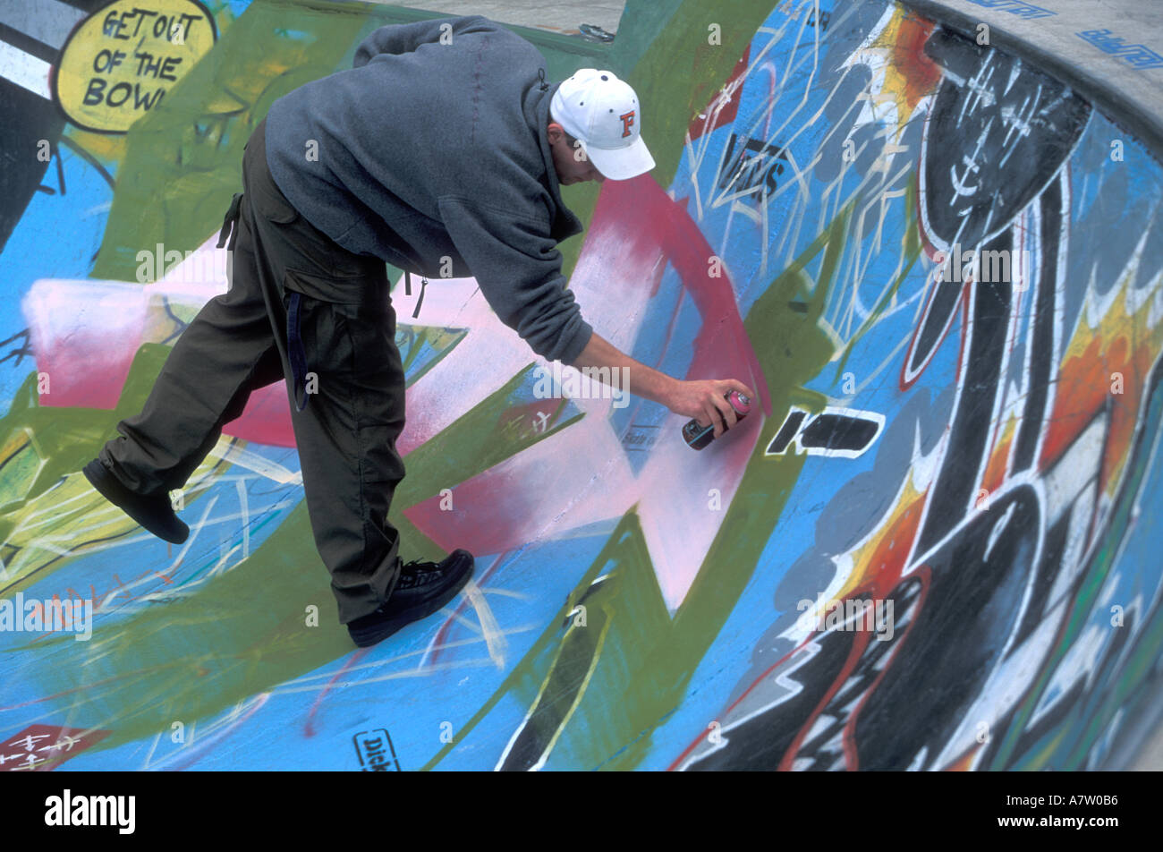 Graffiti artist at work in a park at Holland Road London Stock Photo ...