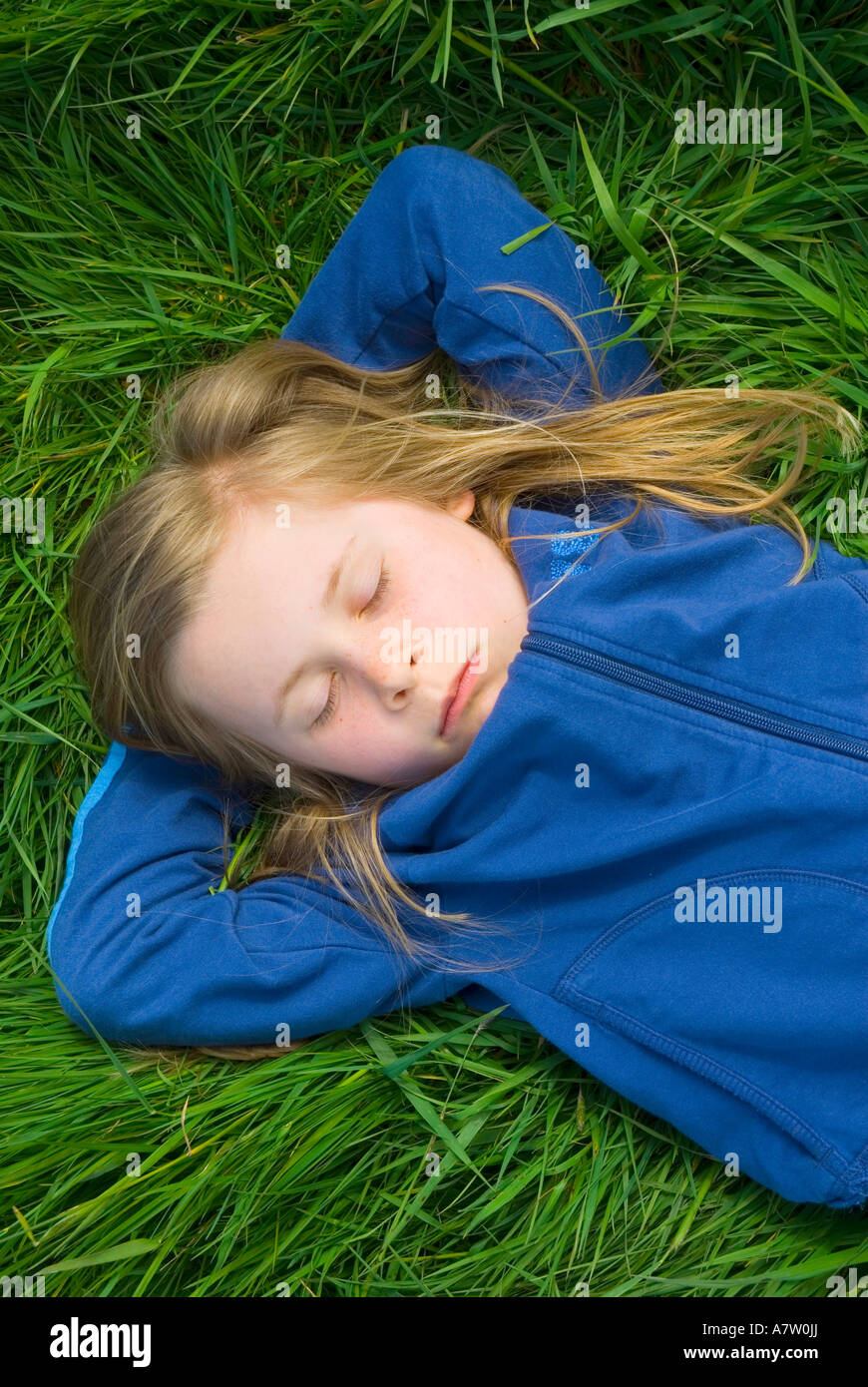 Young girl sleeping in Long Grass Stock Photo - Alamy