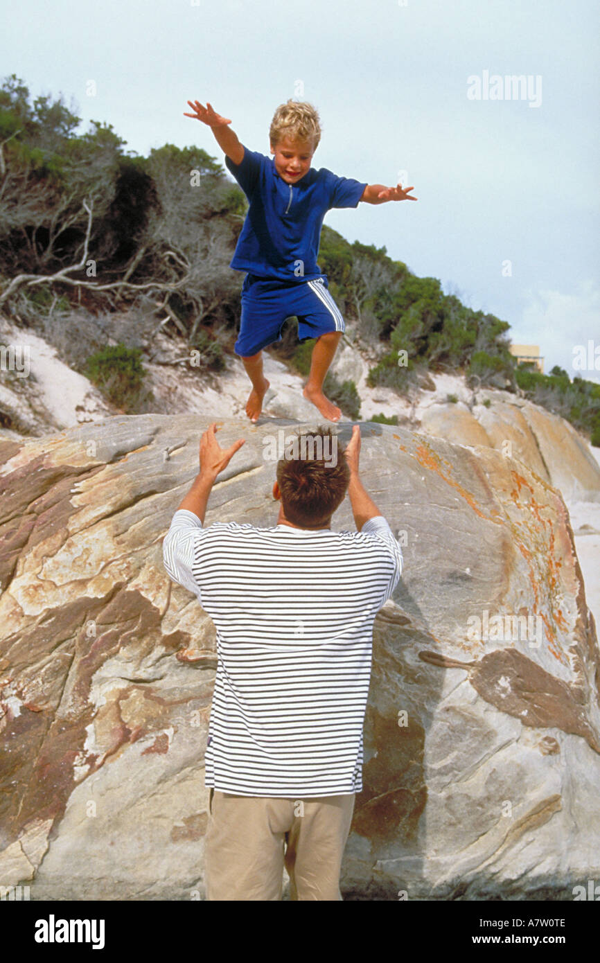 Child jumping fathers arms hi-res stock photography and images - Alamy