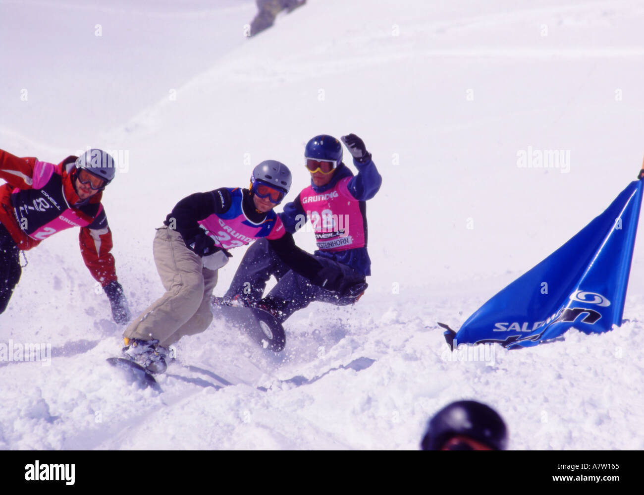 Boarder cross 3 riders round first gate Kaprun Salzburgerland Austria ...