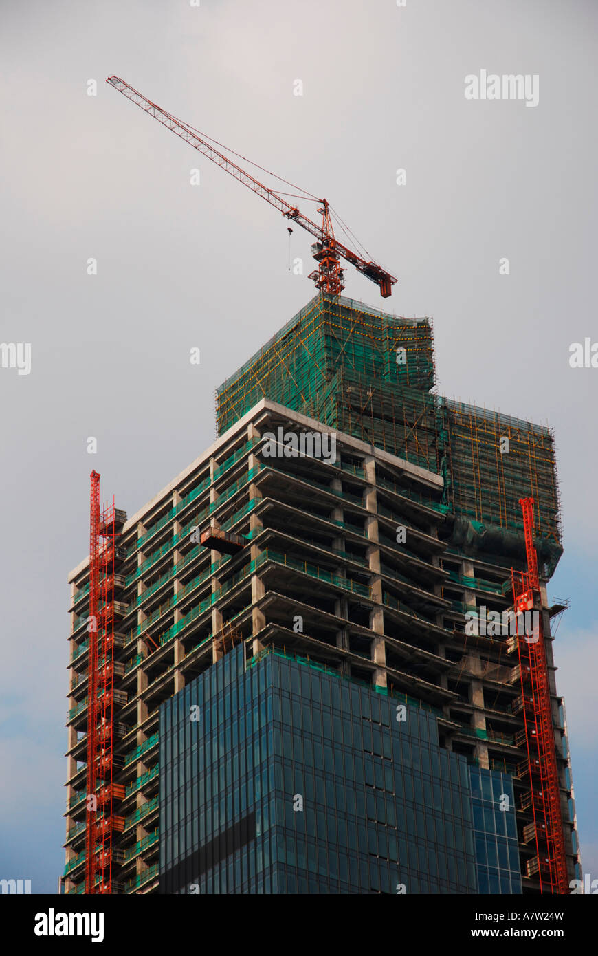 Shanghai skyscraper under construction with crane on roof Stock Photo - Alamy