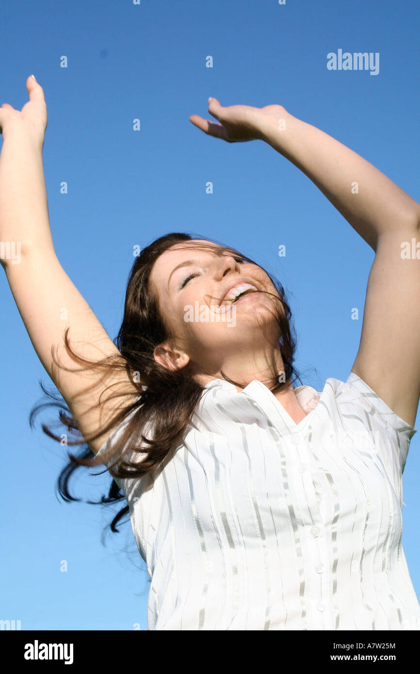 Close-up of young woman raising her hands and smiling Stock Photo - Alamy