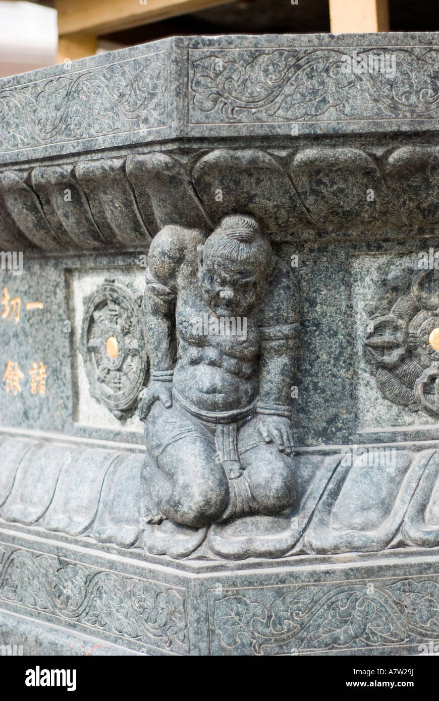 Stone hero statue in The Jing'an Temple of Shanghai Stock Photo - Alamy