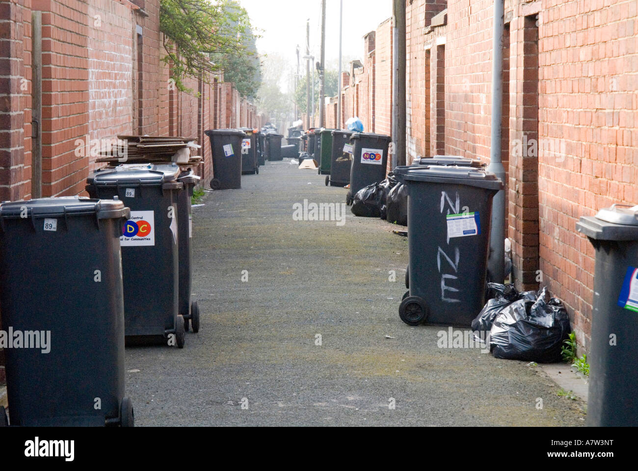 Rubbish Bins in Back Alley Stock Photo - Alamy