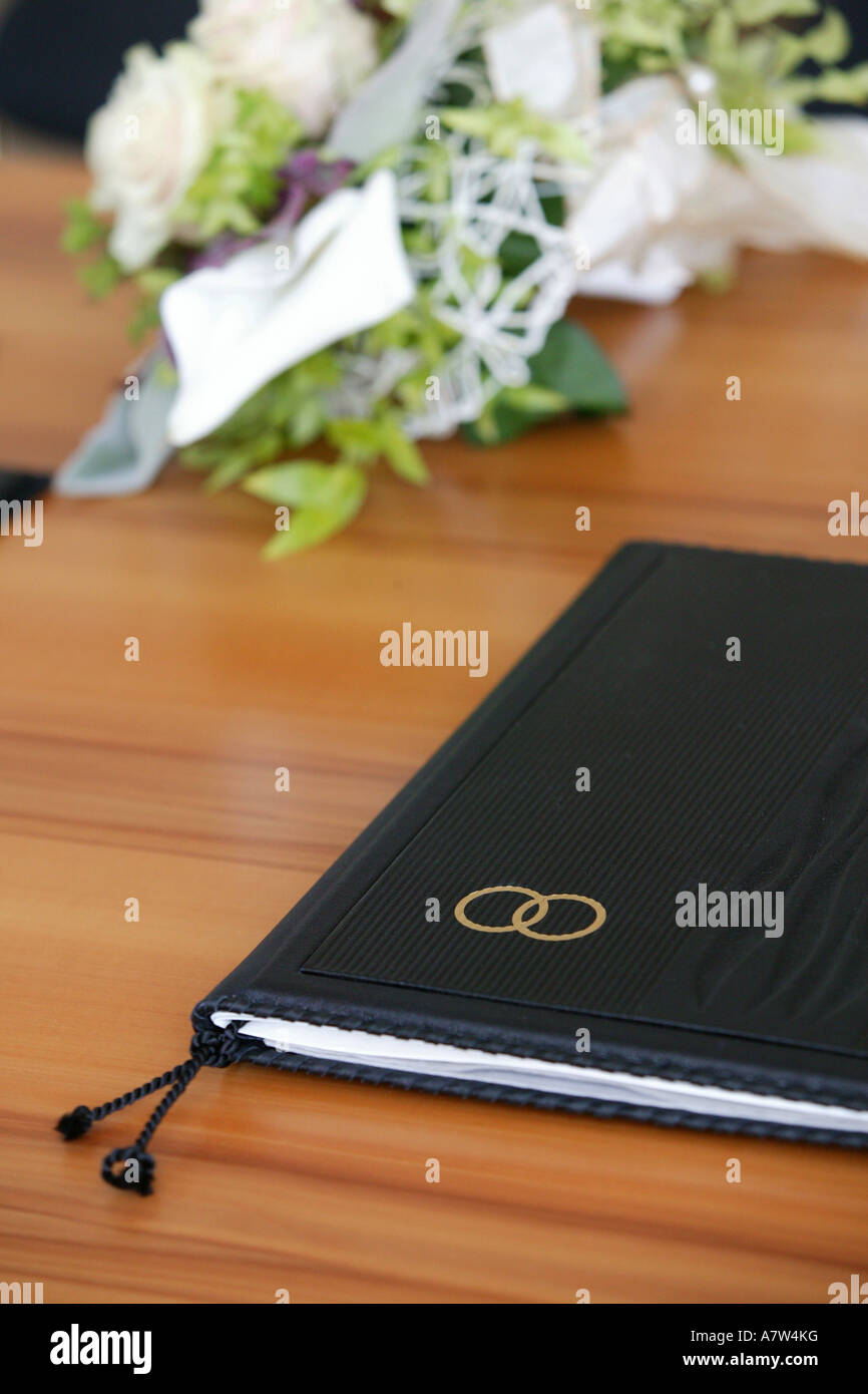 Register and flower decoration on desk Stock Photo - Alamy