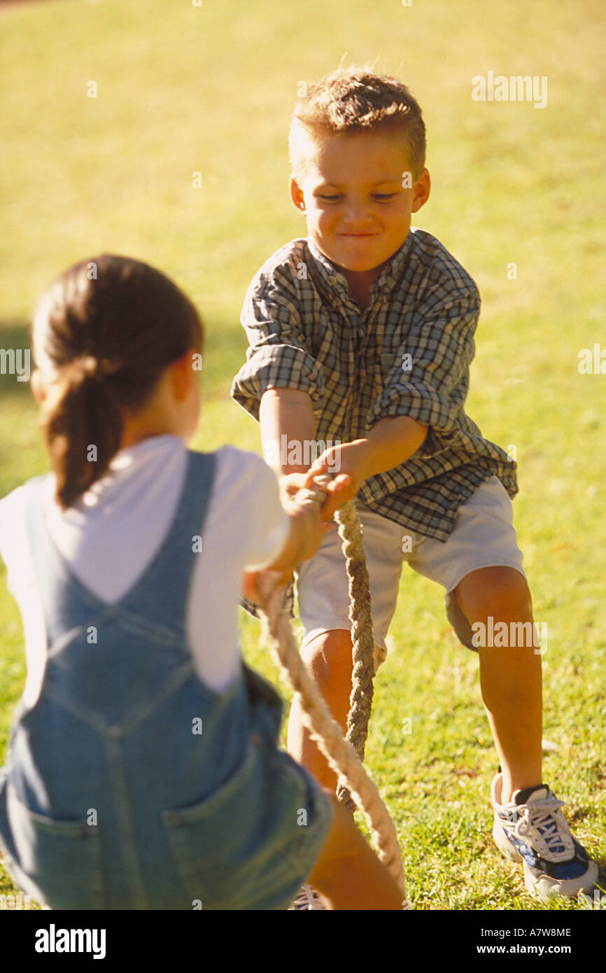 portrait of a girl and boy pulling a rope Stock Photo - Alamy