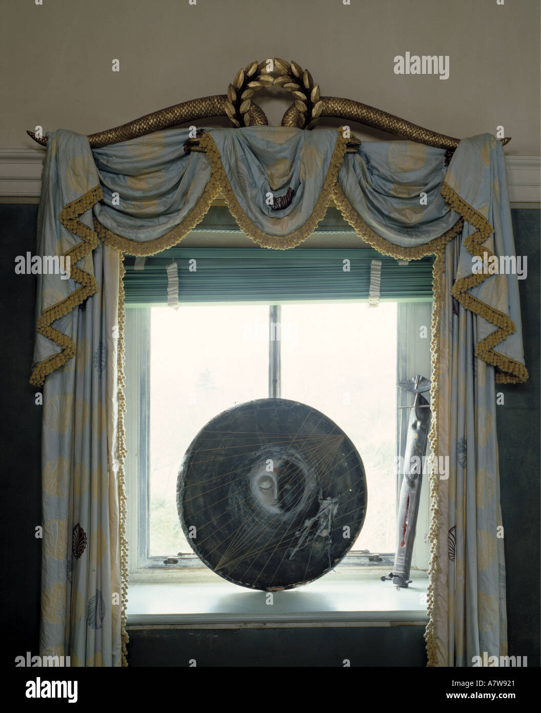 Gold carving above window with turquoise blind and swagged and tailed ...