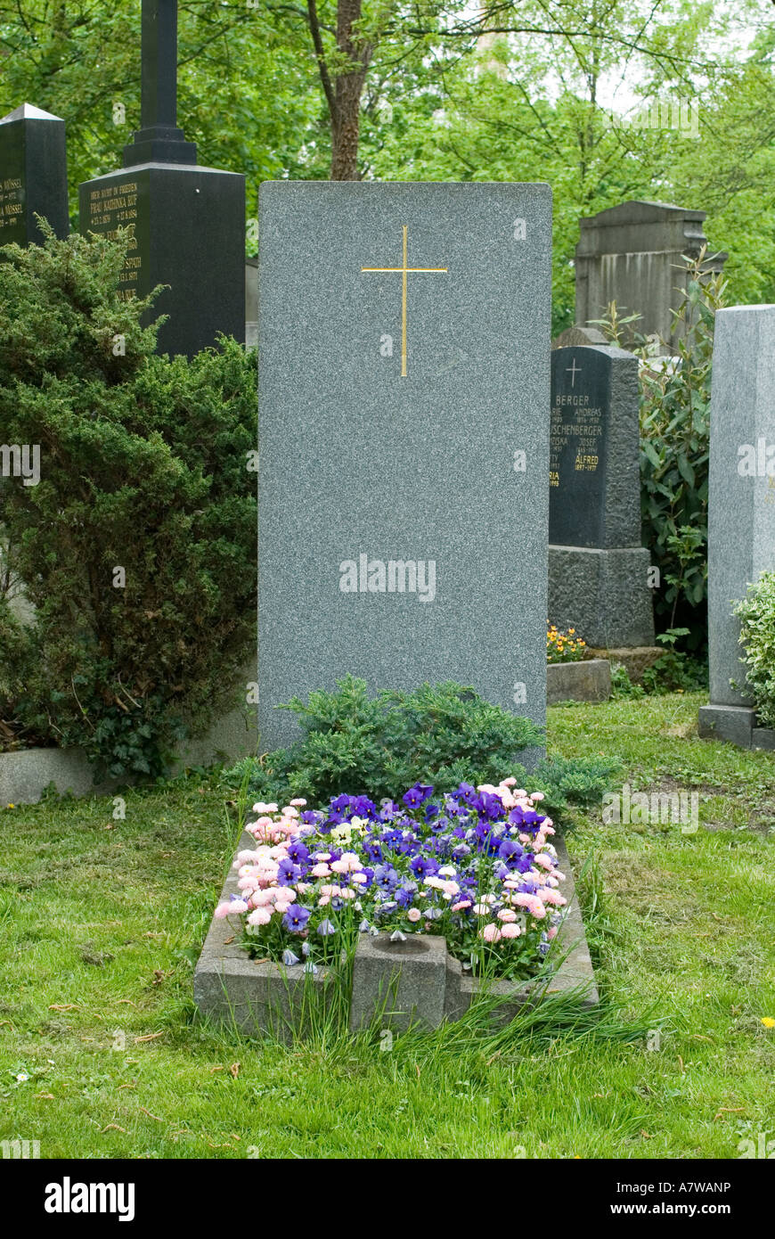 christian grave stone and flowers on graveyard Munich Bavaria Germany ...