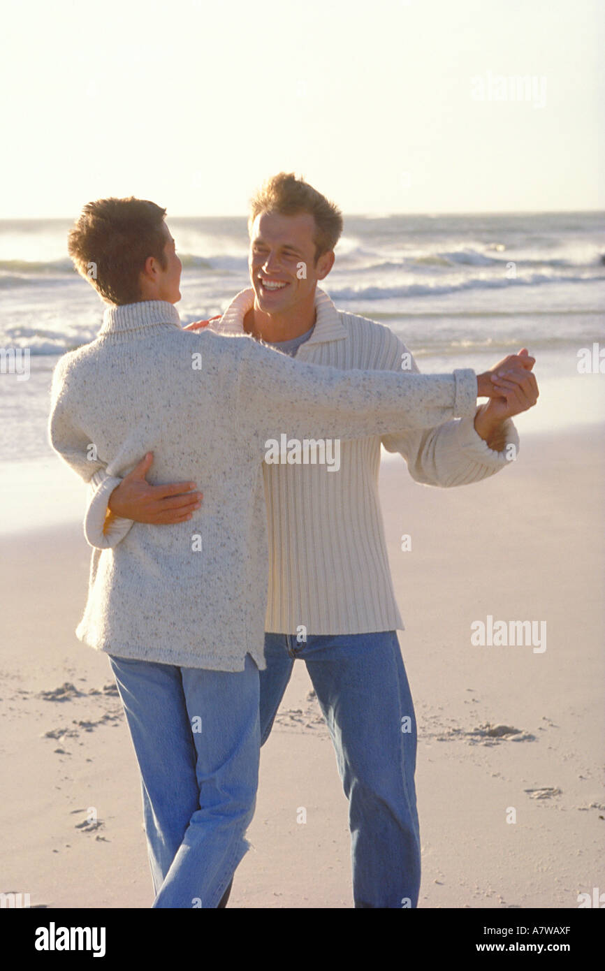portrait of young couple dancing at the beach Stock Photo - Alamy