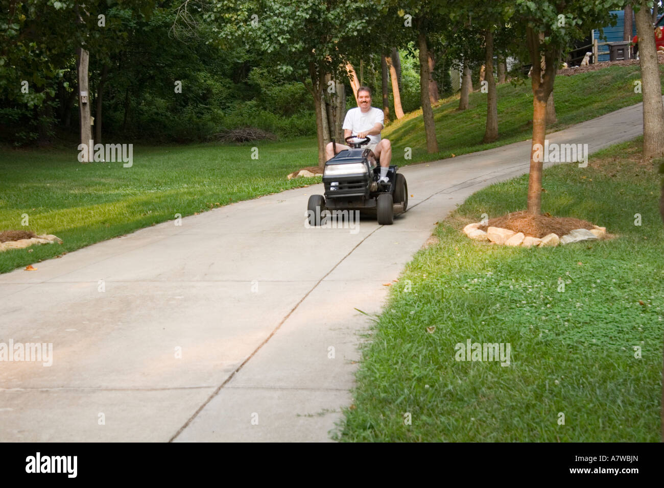 Man sitting on lawn mower hi-res stock photography and images - Alamy