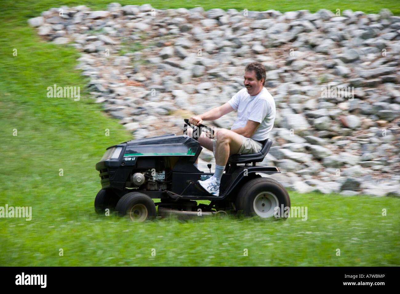 Man sitting on lawn mower hi-res stock photography and images - Alamy