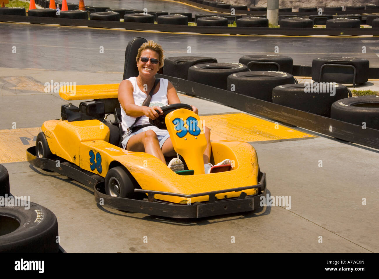 Woman enjoying go-carting Stock Photo - Alamy