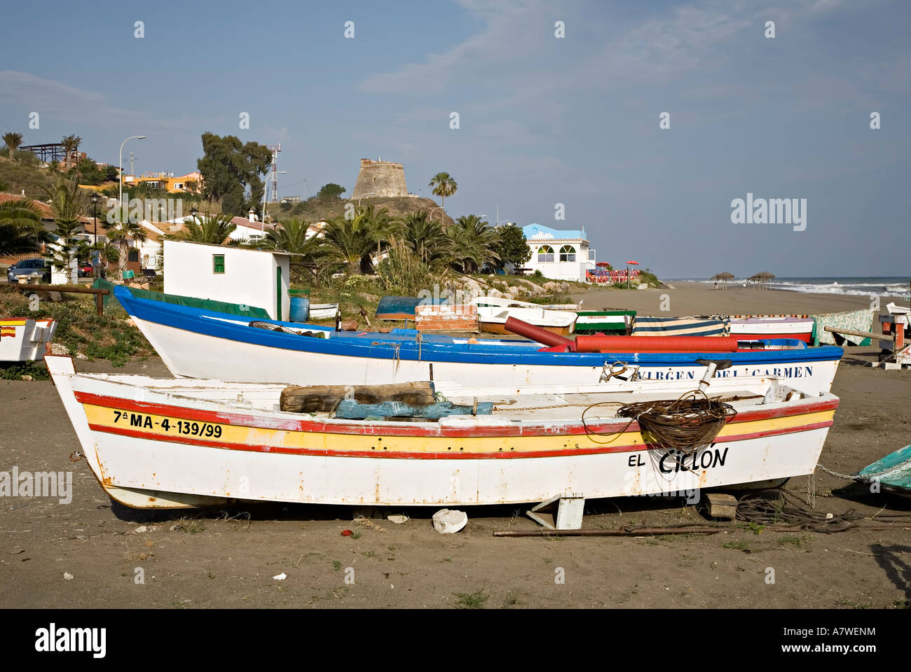 Boat on beach and ruined watchtower at Rincon de la Victoria Costa del ...
