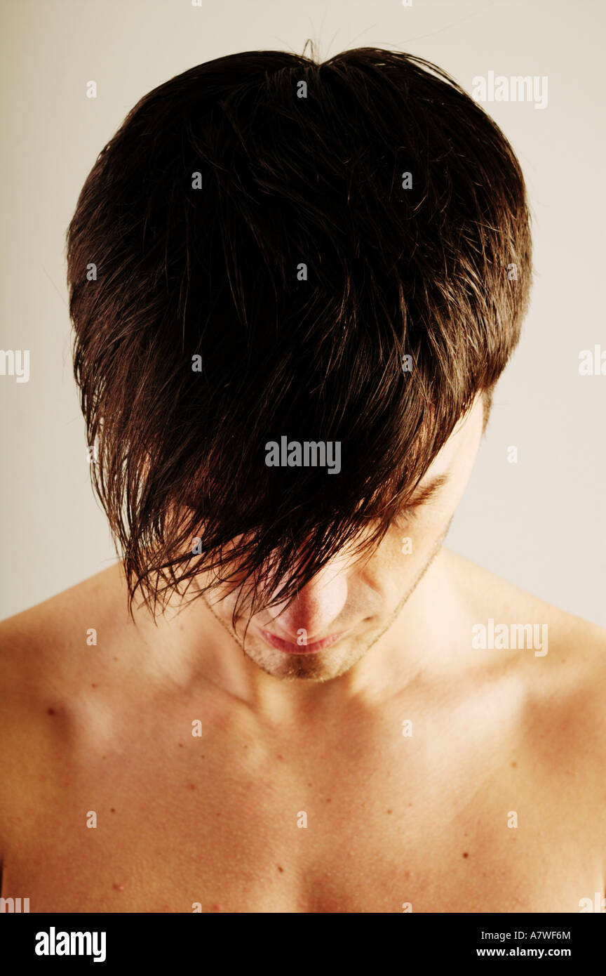 Head of a young man looking downwards Stock Photo - Alamy
