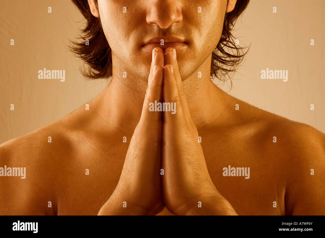 Young man folds his hands Stock Photo - Alamy