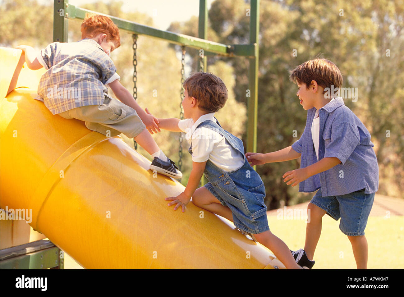 group of children climbing on a slide Stock Photo - Alamy