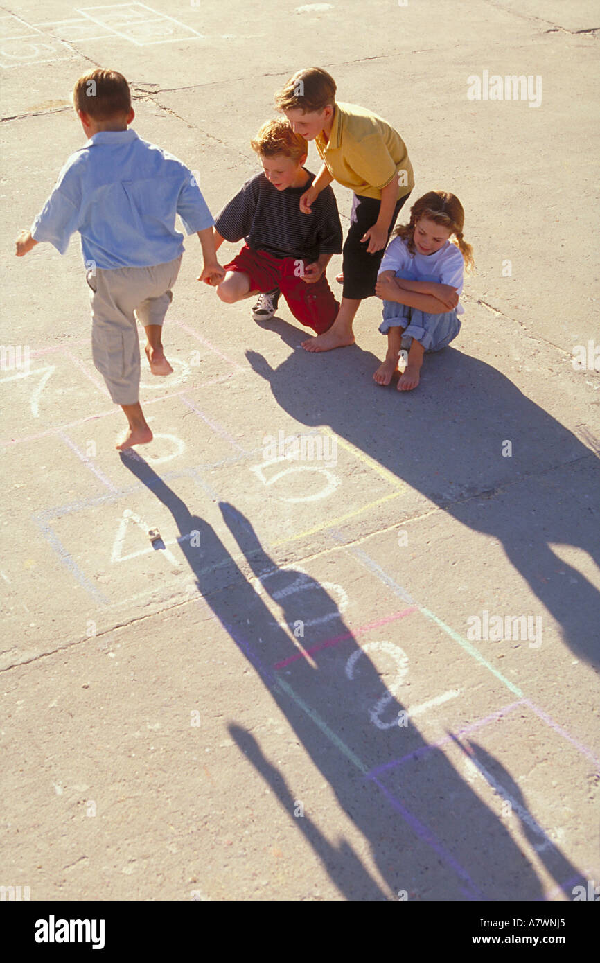 group of children playing hopscotch Stock Photo - Alamy