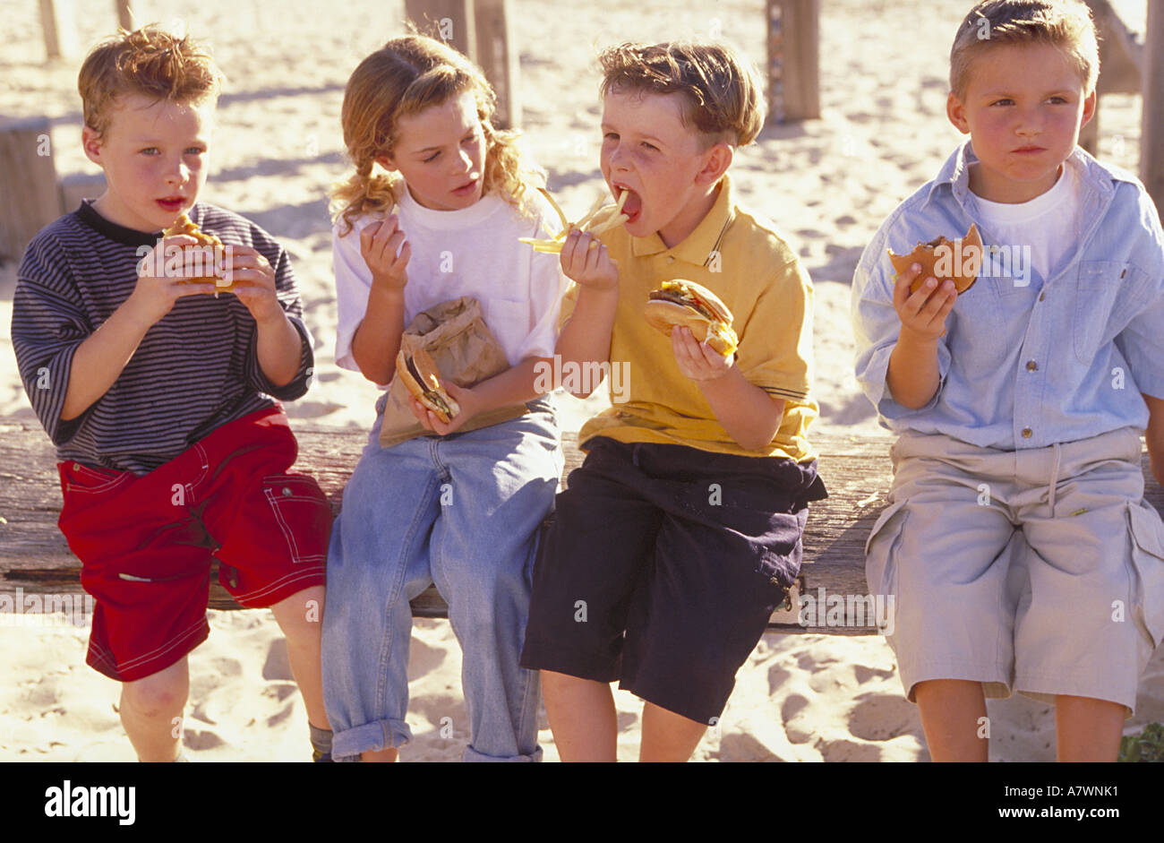 portrait of a group of children eating fast food Stock Photo - Alamy